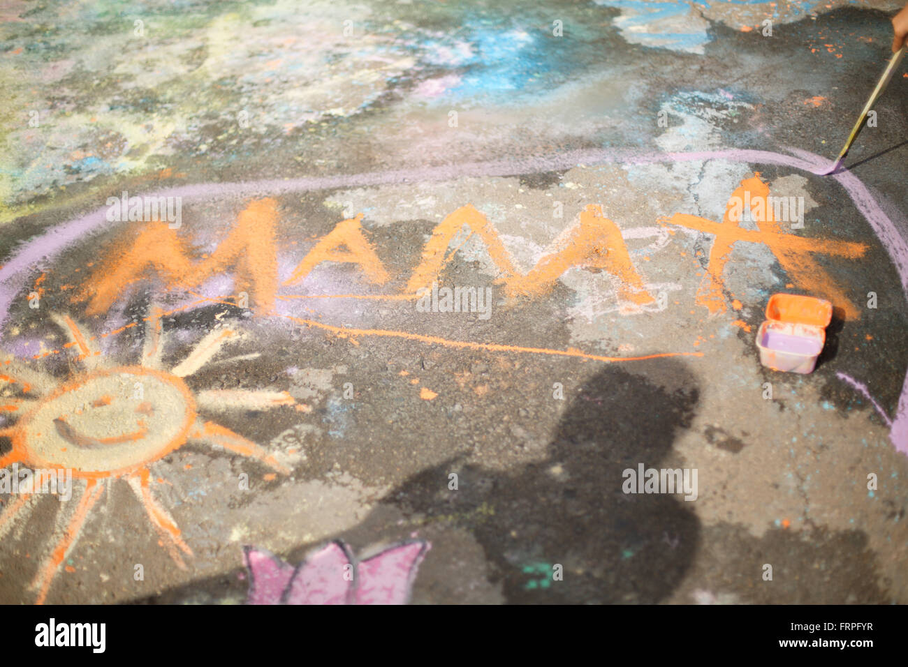 Children painting on the ground Stock Photo - Alamy