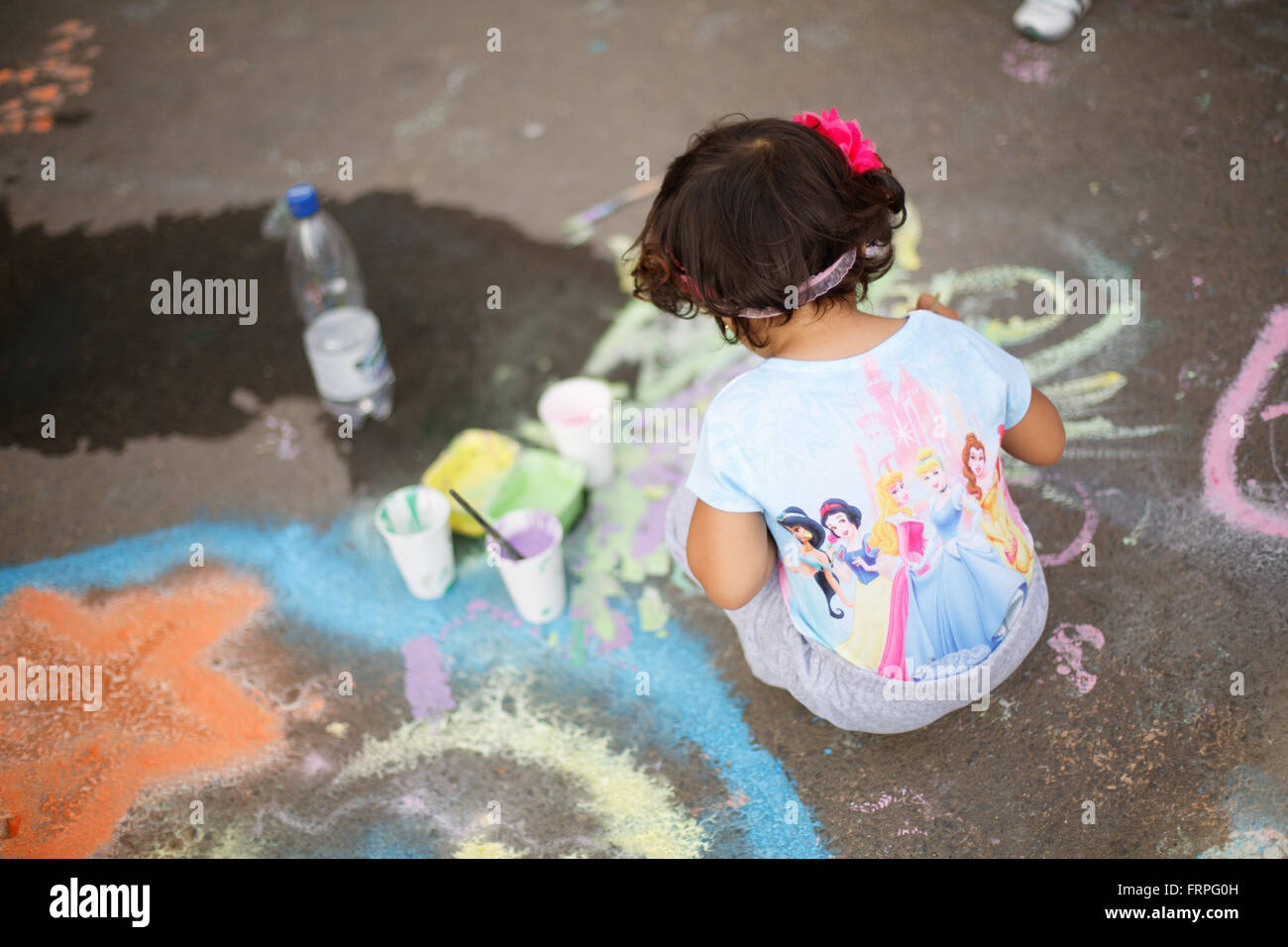 Children painting on the ground Stock Photo - Alamy