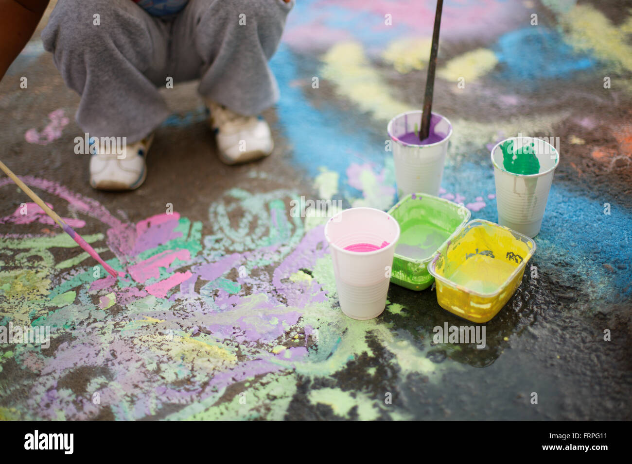 Children painting on the ground Stock Photo - Alamy