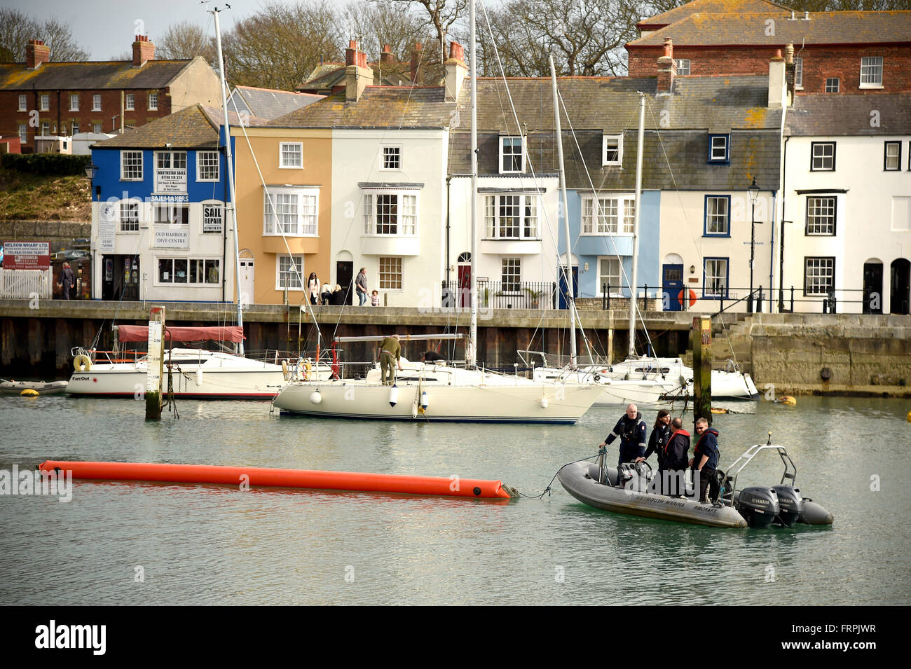 Oil pollution containment boom deployment exercise at Weymouth Harbour ...