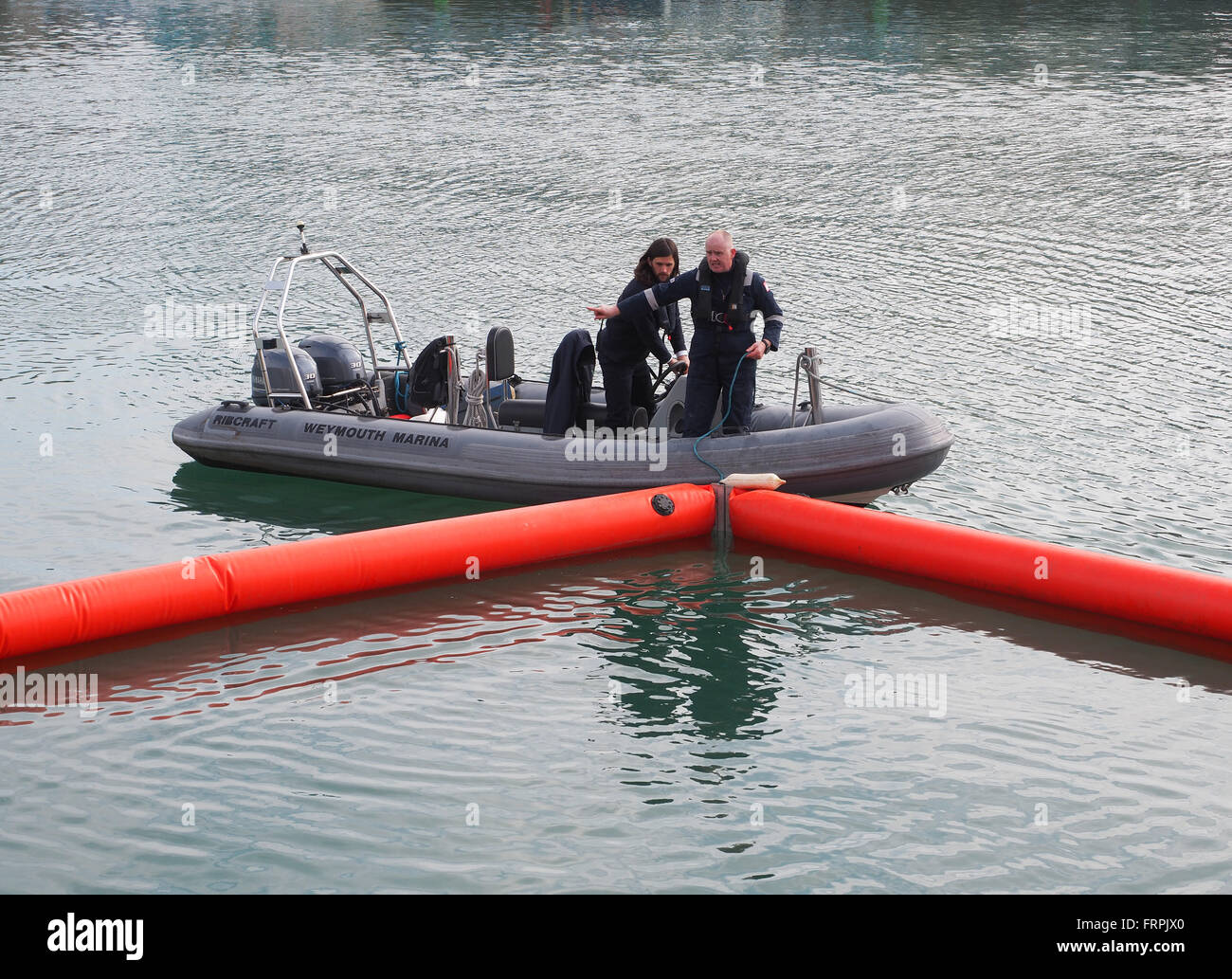 Oil pollution containment boom deployment exercise at Weymouth Harbour ...