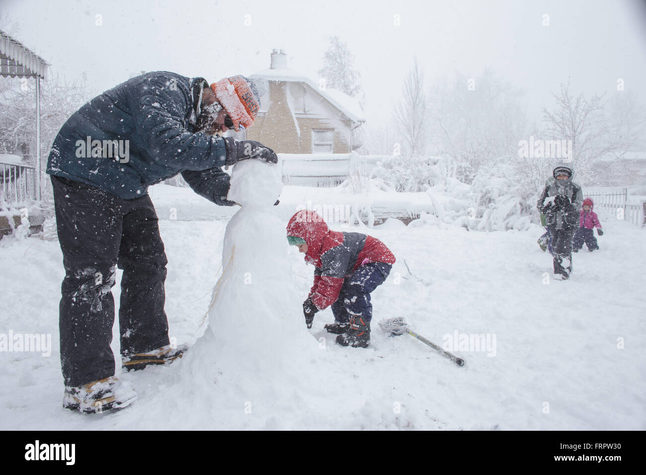 Denver, Colorado, USA. 23rd Mar, 2016. A family makes a snow man during ...