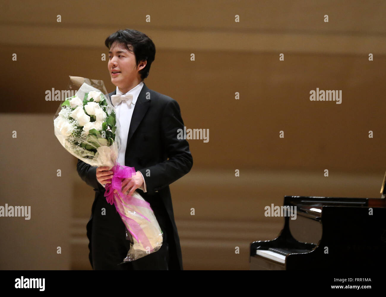 New York, USA. 23rd Mar, 2016. Pianist Li Yundi greets the audience ...