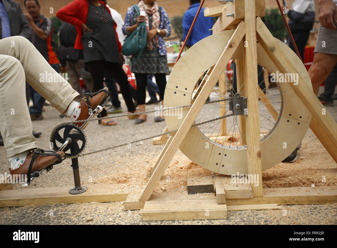 Kathmandu, Nepal. 24th Mar, 2016. A woman peddles a woodwork cycle made ...