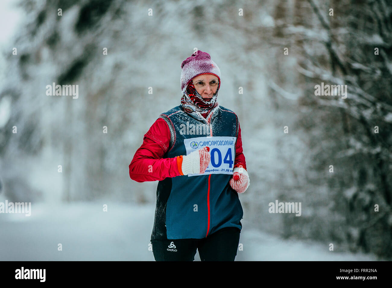 closeup male runner average years of running in winter woods during ...