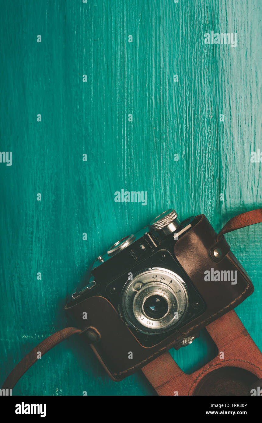 Vintage photo camera on rustic blue background Stock Photo - Alamy