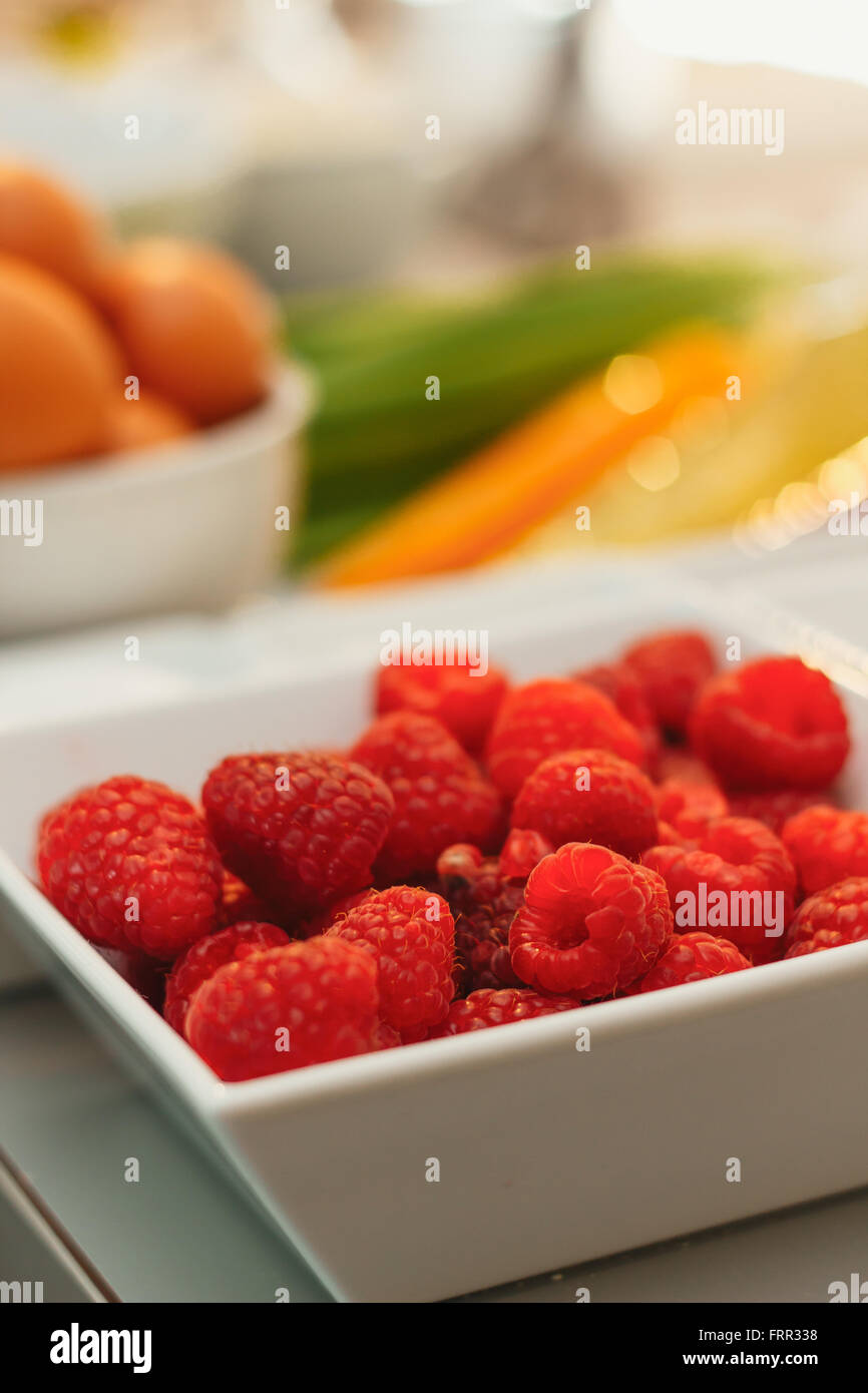 in the kitchen on a square plate raspberries Stock Photo - Alamy