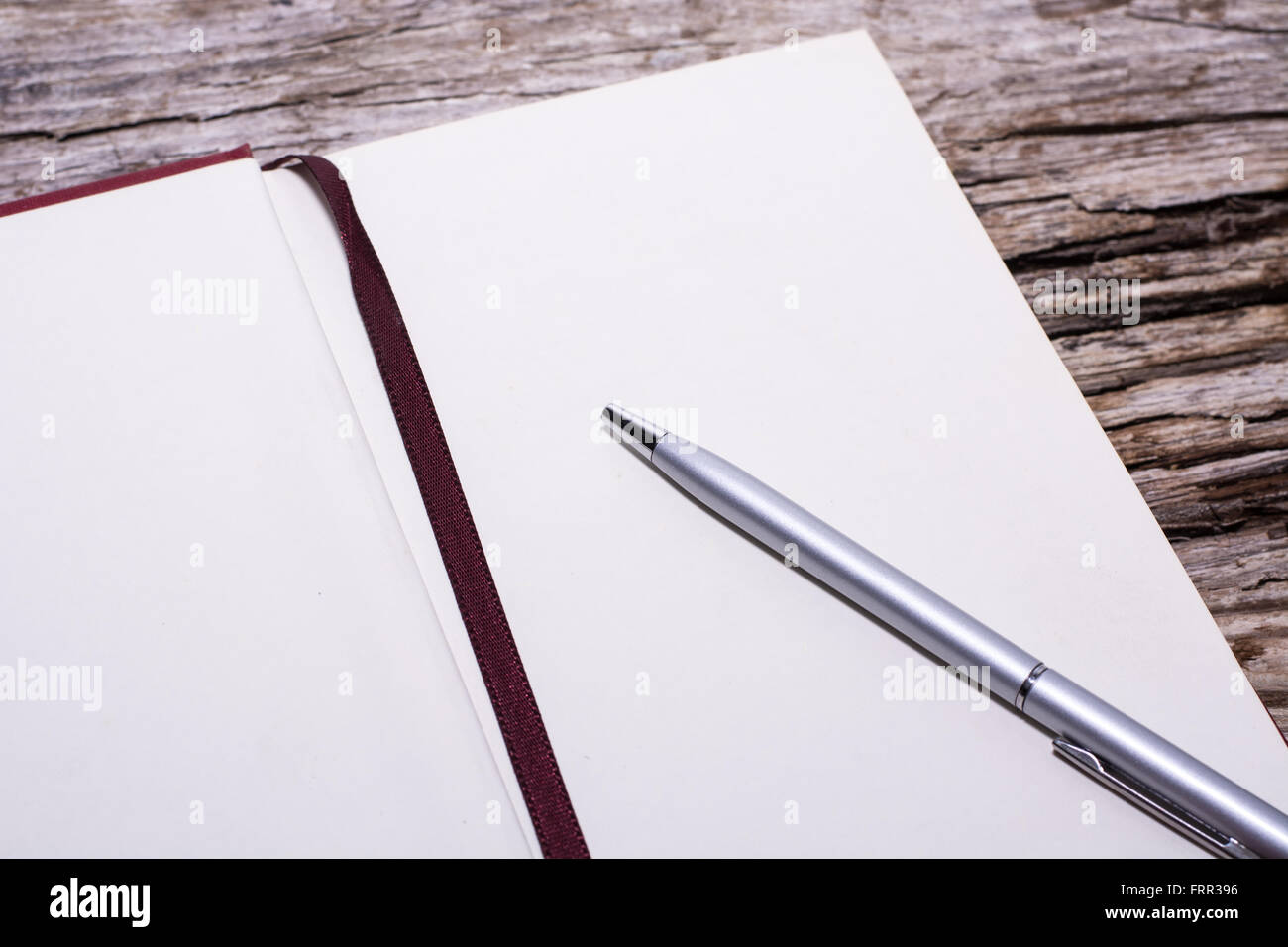 book and pen on wood background Stock Photo - Alamy
