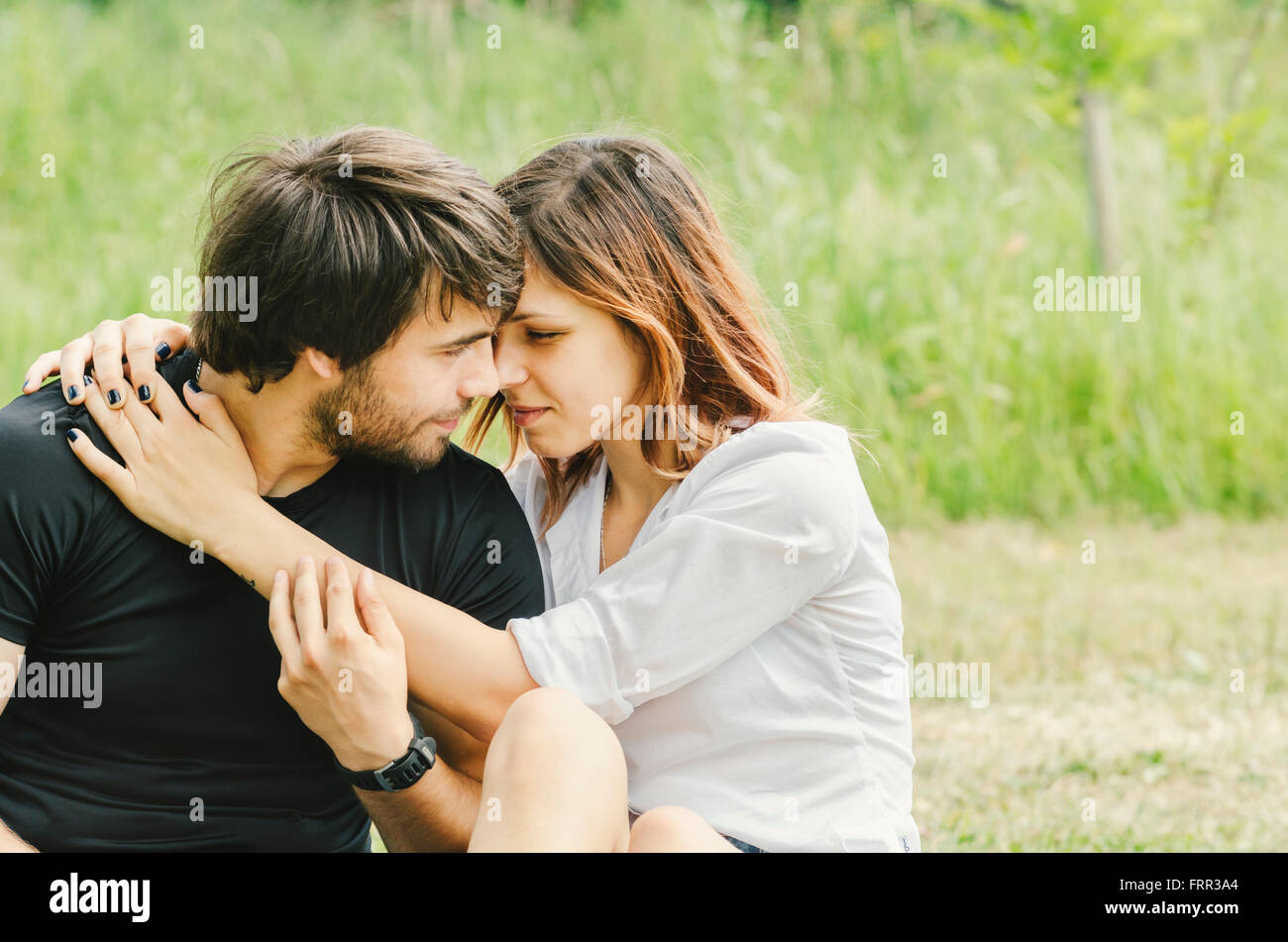 Happy couple hugging in nature Stock Photo - Alamy