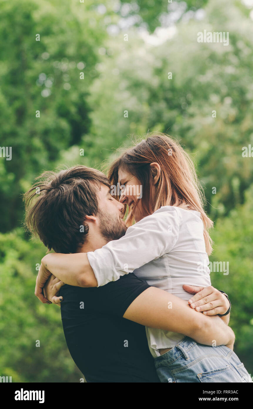 Happy couple hugging in nature Stock Photo - Alamy