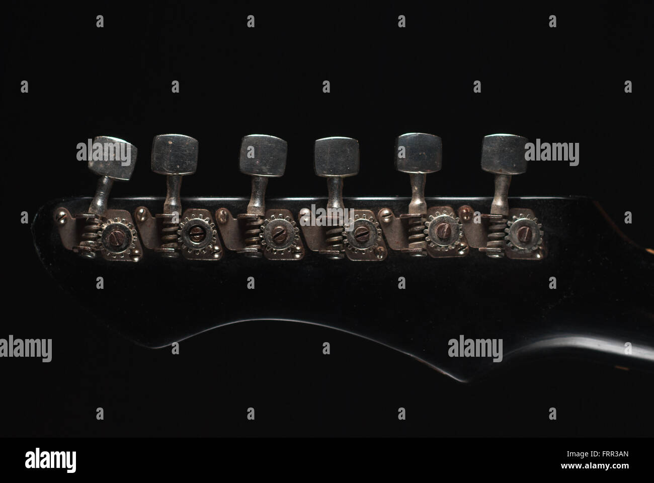 the mechanism of a tension of strings on the fingerboard of an old ...