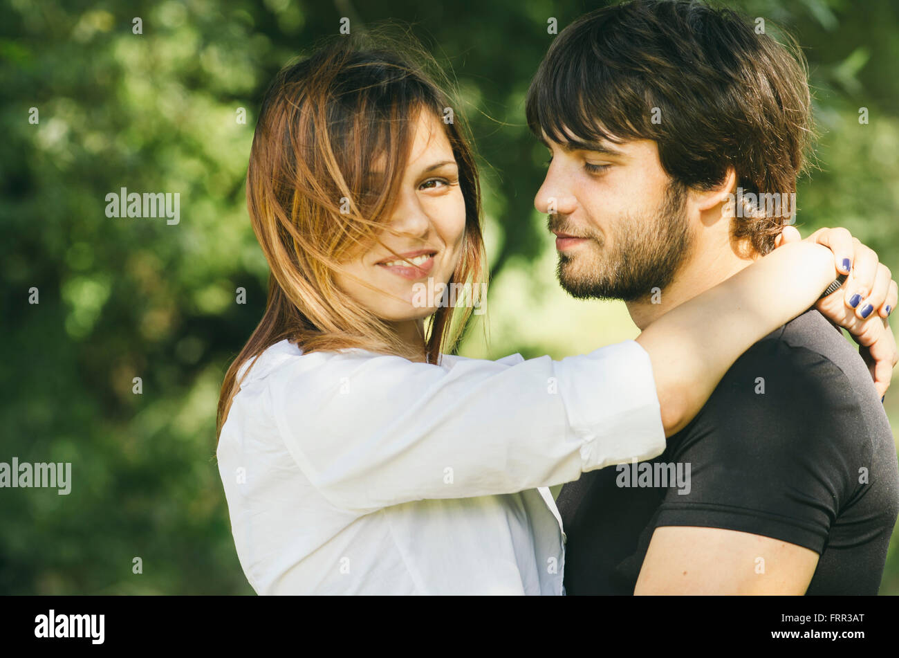 Happy couple hugging in nature Stock Photo - Alamy