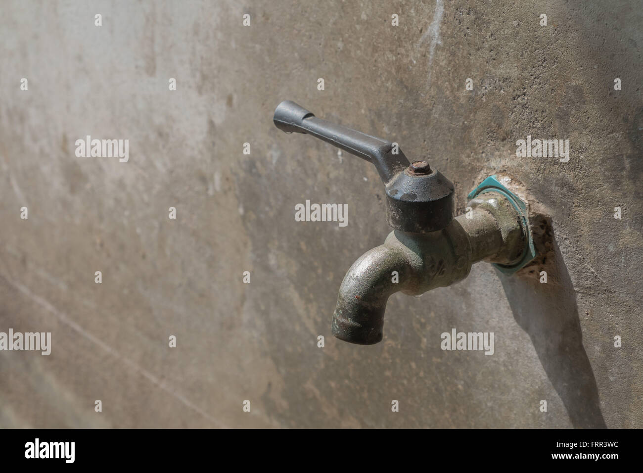 old faucet on concrete wall, save the water concept Stock Photo - Alamy