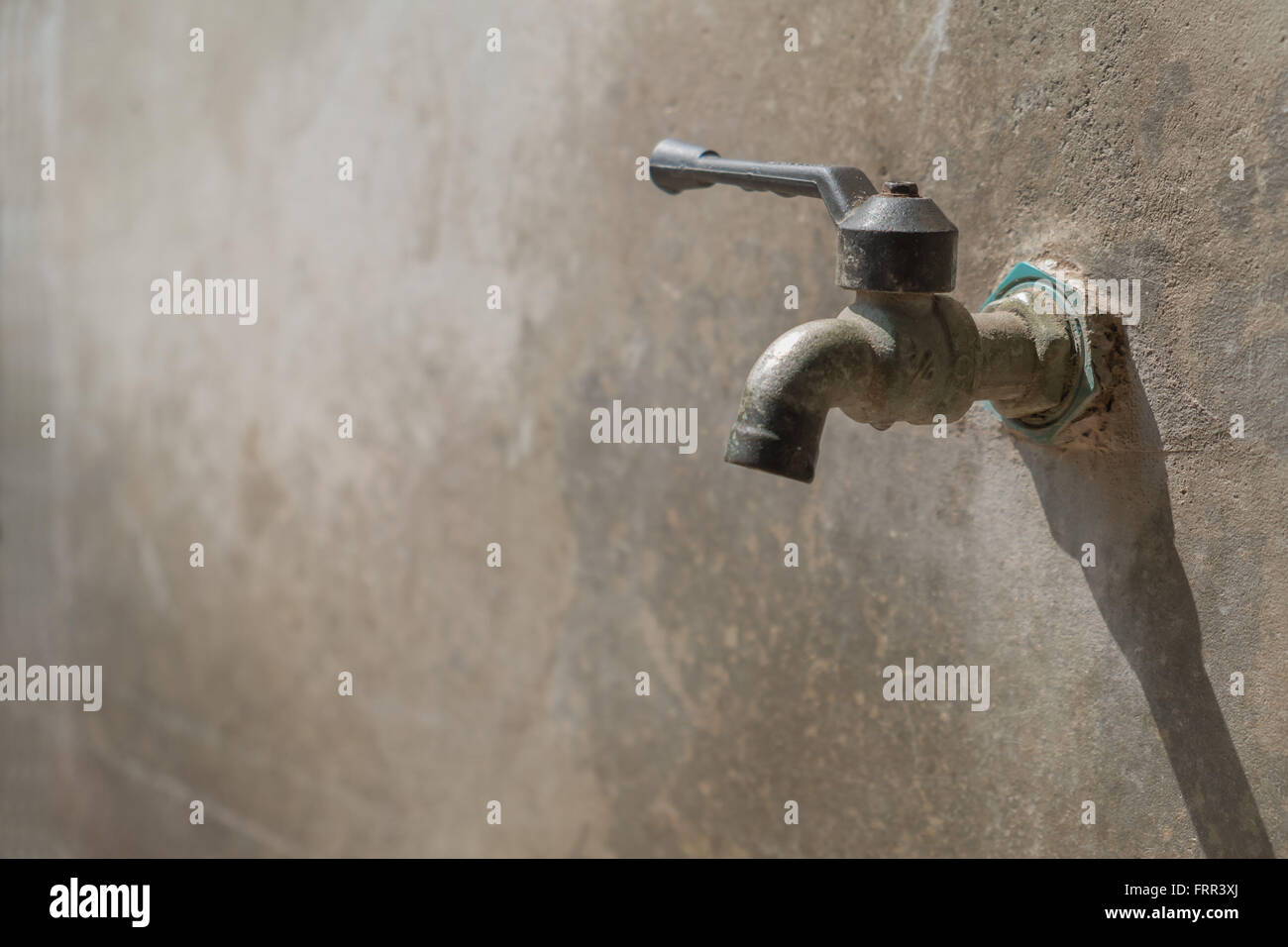 old faucet on concrete wall, save the water concept Stock Photo - Alamy