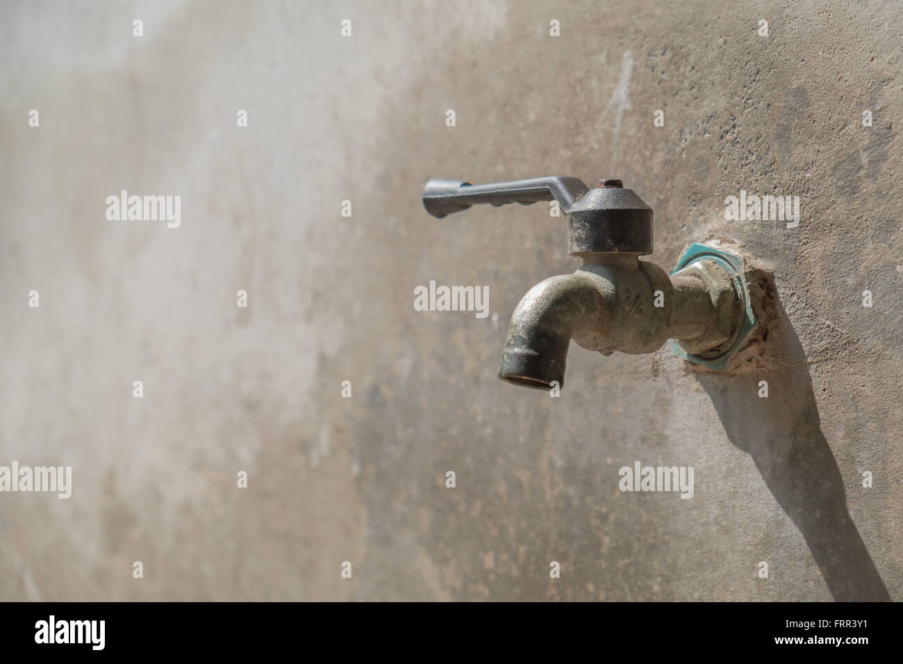old faucet on concrete wall, save the water concept Stock Photo - Alamy