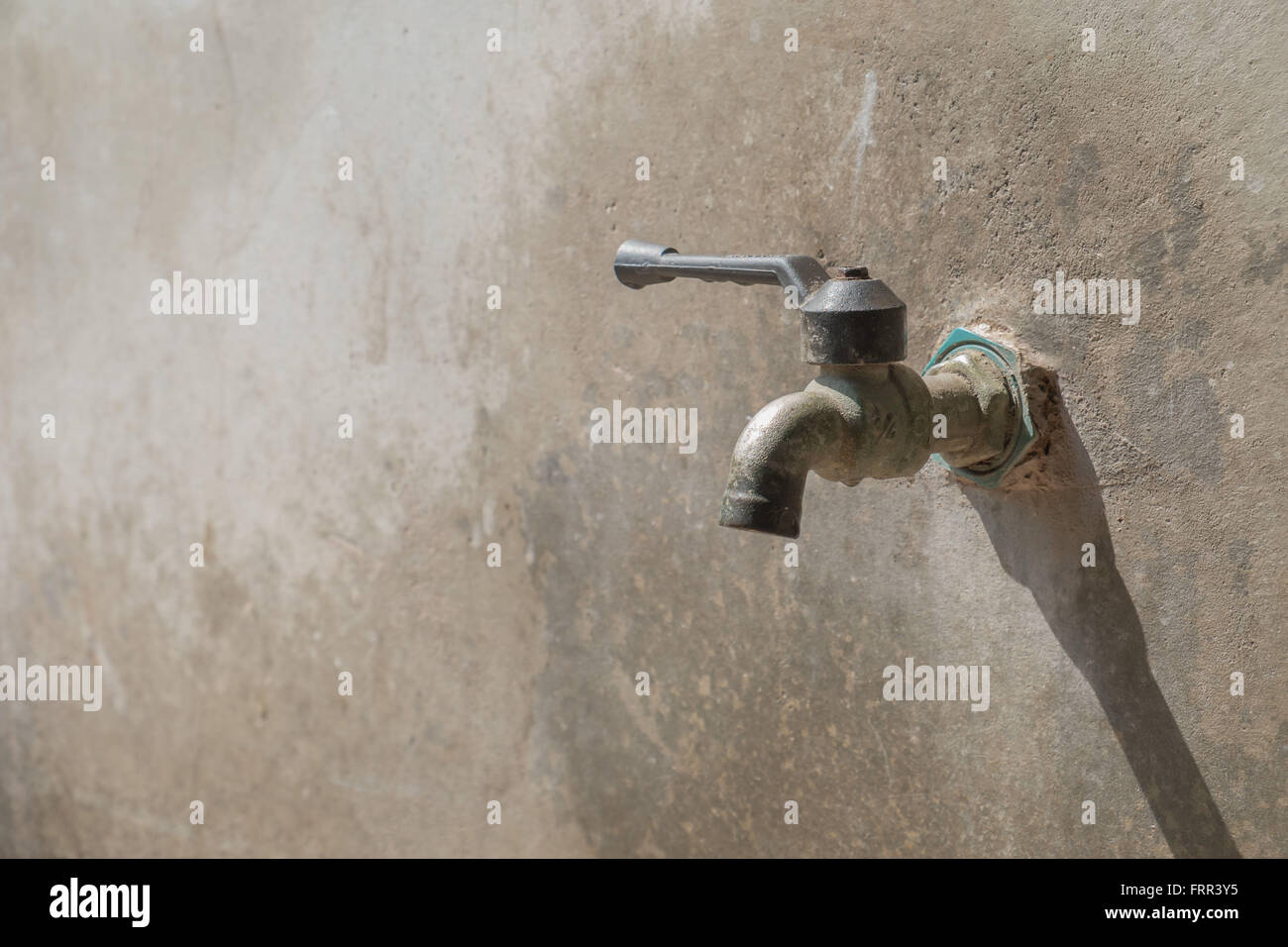 old faucet on concrete wall, save the water concept Stock Photo - Alamy