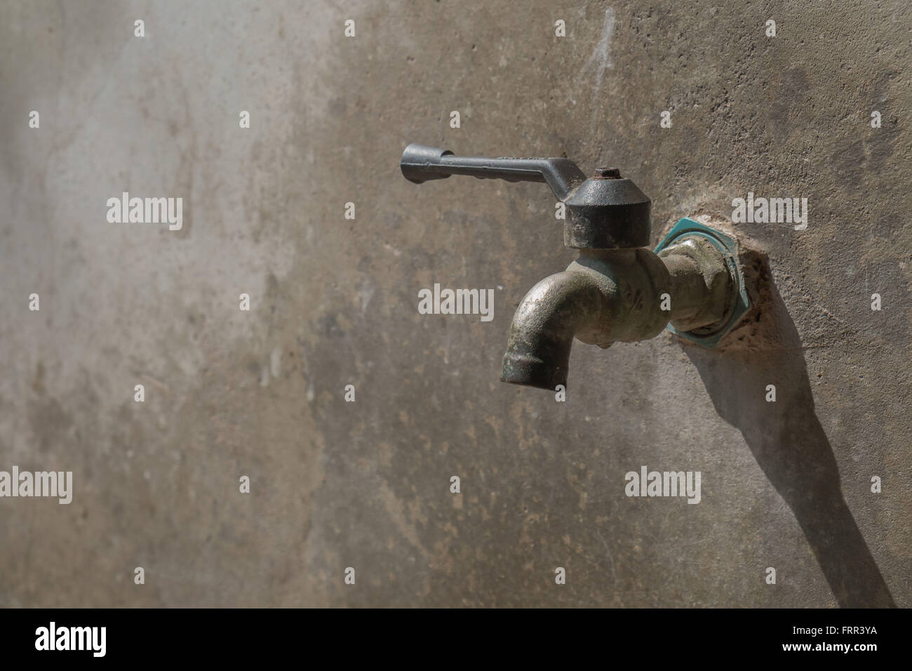 old faucet on concrete wall, save the water concept Stock Photo - Alamy