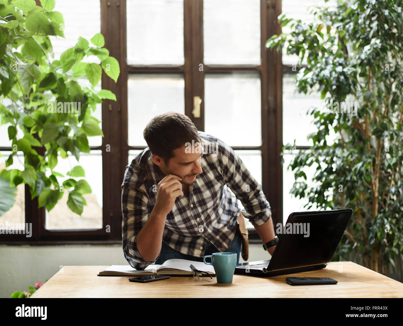 Young man working in cool workspace Stock Photo - Alamy