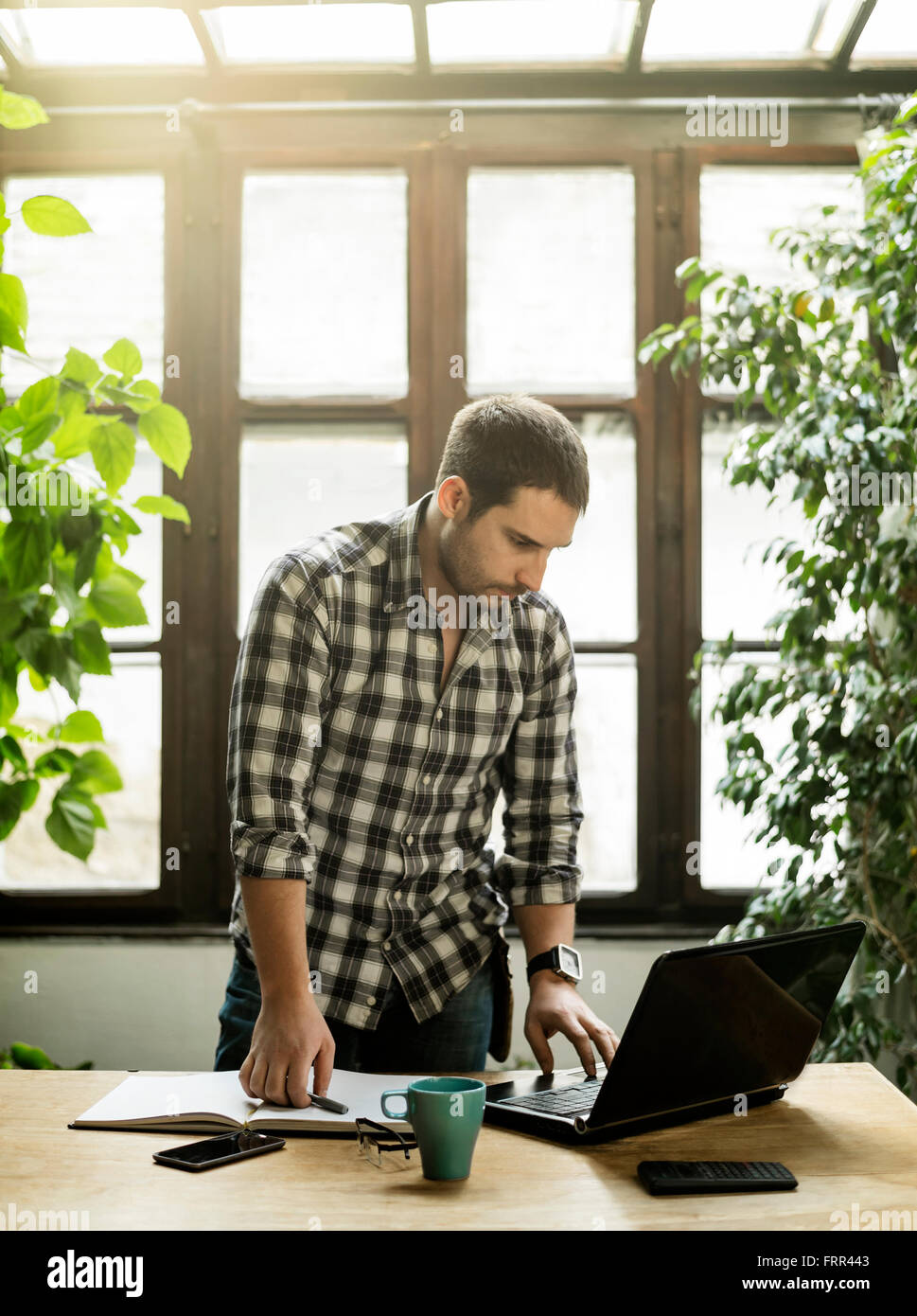 Young man working in cool workspace Stock Photo - Alamy