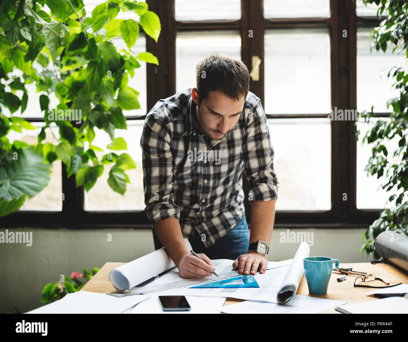 Young man working on his project Stock Photo - Alamy