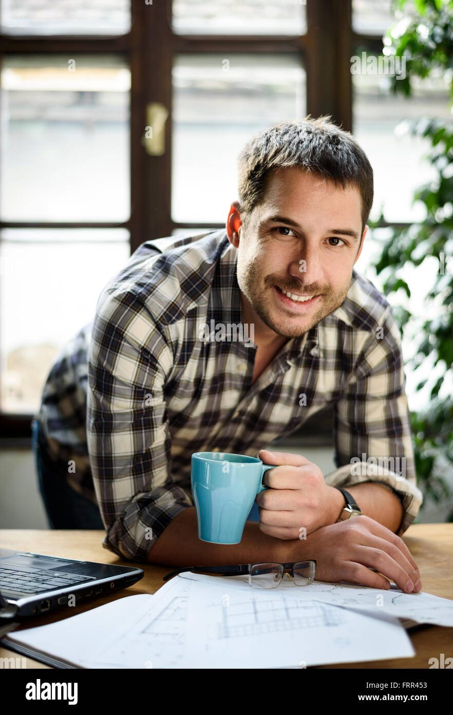Young man working in cool workspace Stock Photo - Alamy