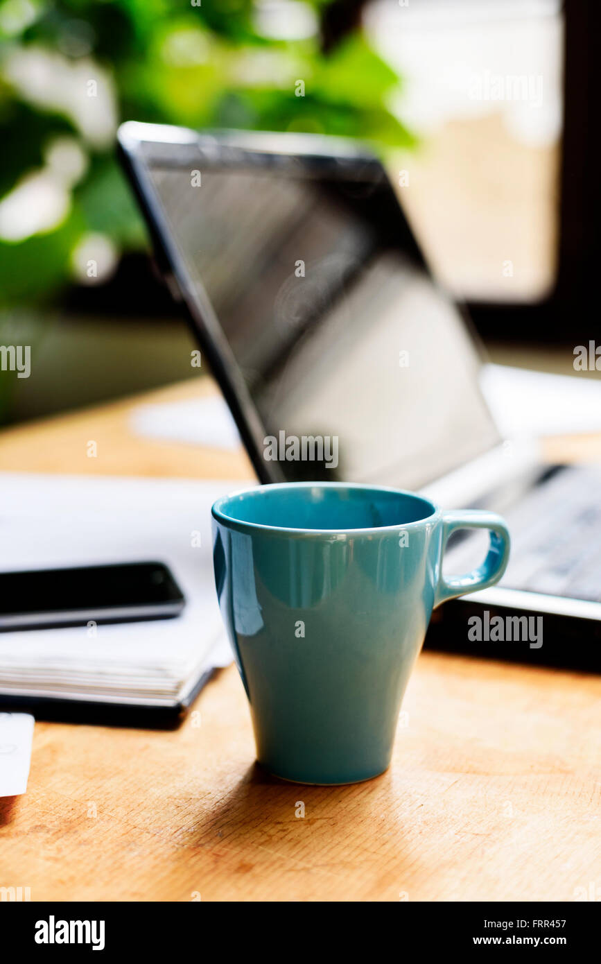 Working desk with laptop, notebook and coffee cup Stock Photo - Alamy