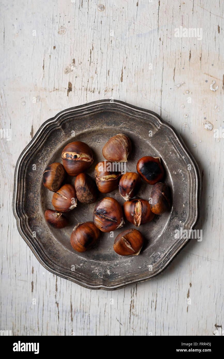 Roasted chestnuts in rustic silver plate Stock Photo - Alamy