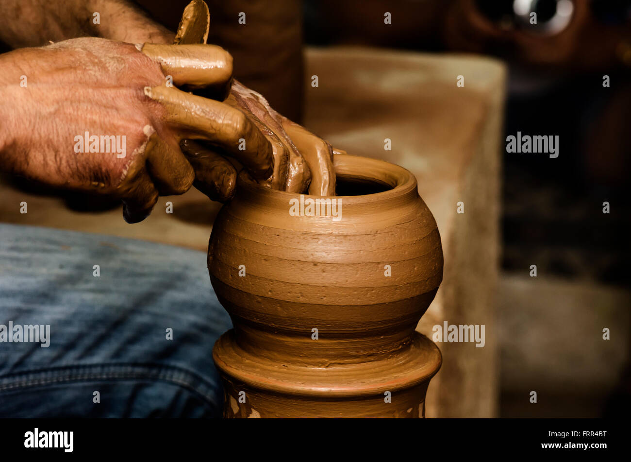 Potter shaping clay on the pottery wheel Stock Photo - Alamy