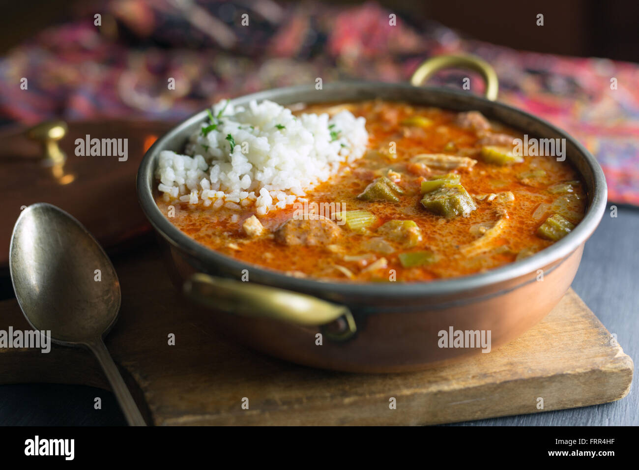 Copper pot filled with sausage gumbo and a scoop of rice Stock Photo ...