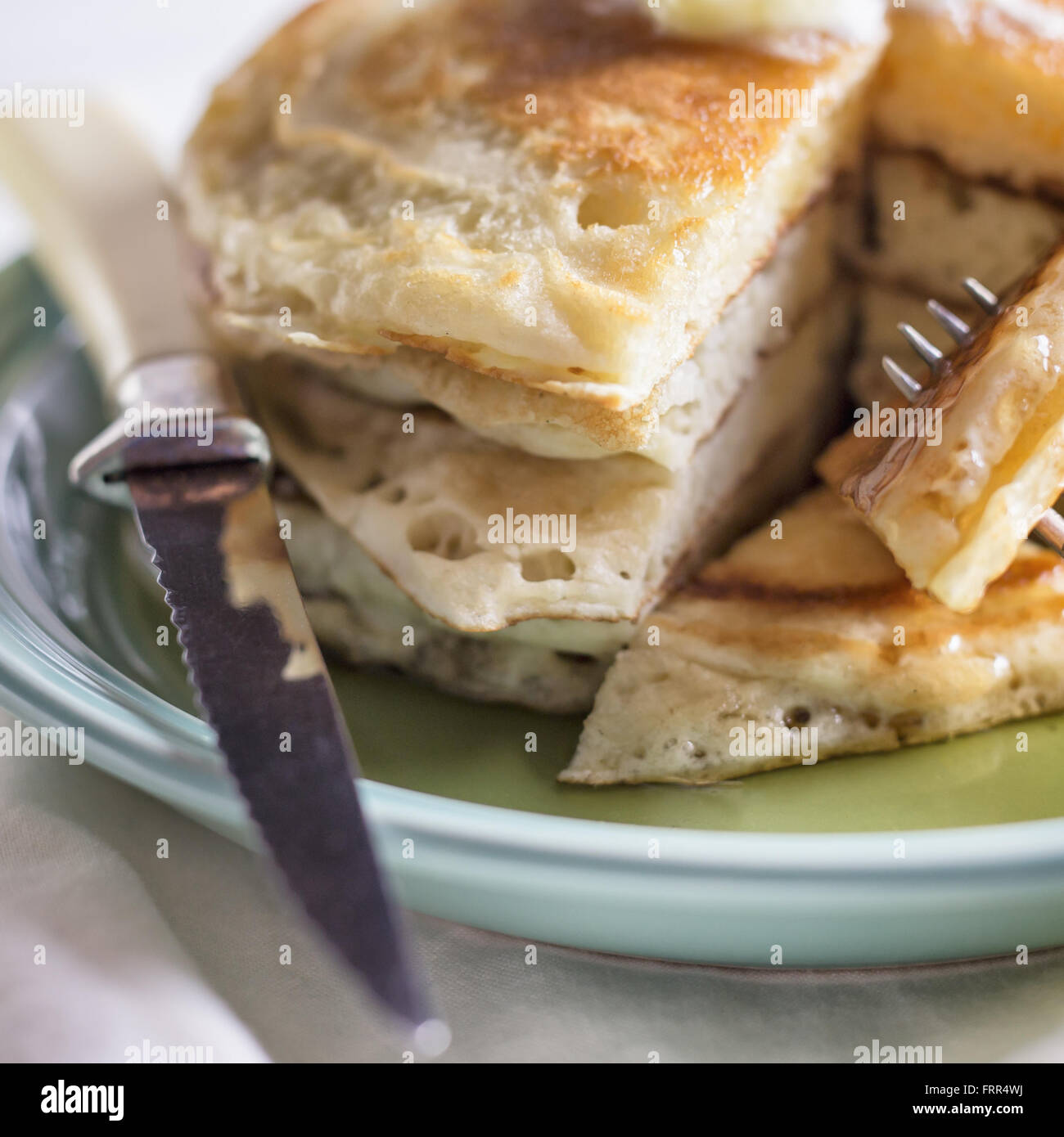 A small stack of sliced pancakes with butter and syrup Stock Photo - Alamy