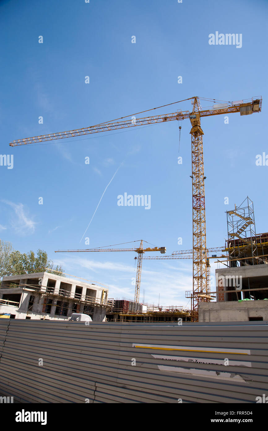two construction cranes working on a building site Stock Photo - Alamy