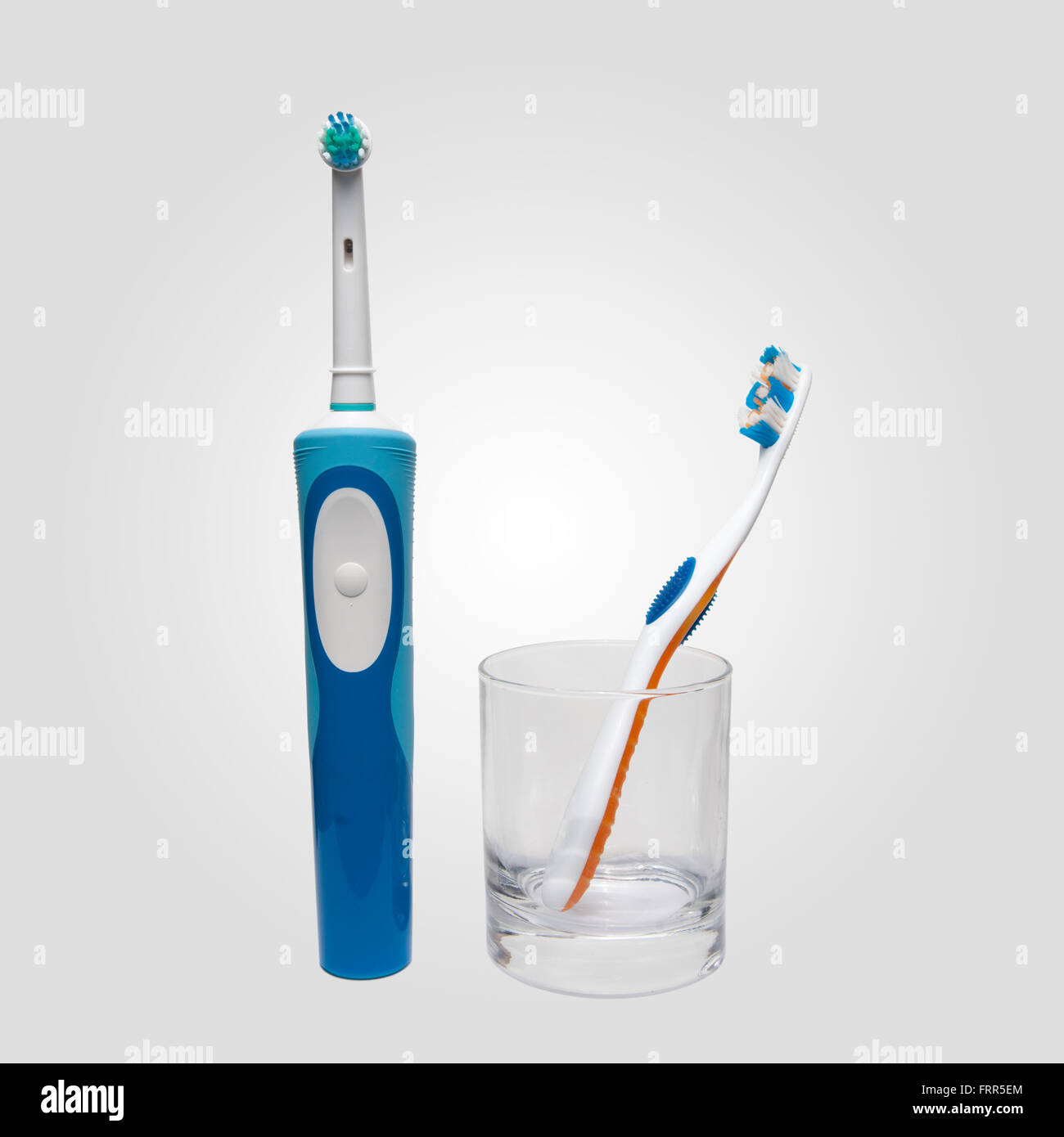 hi-tech electric toothbrush and traditional toothbrush in a glass Stock ...