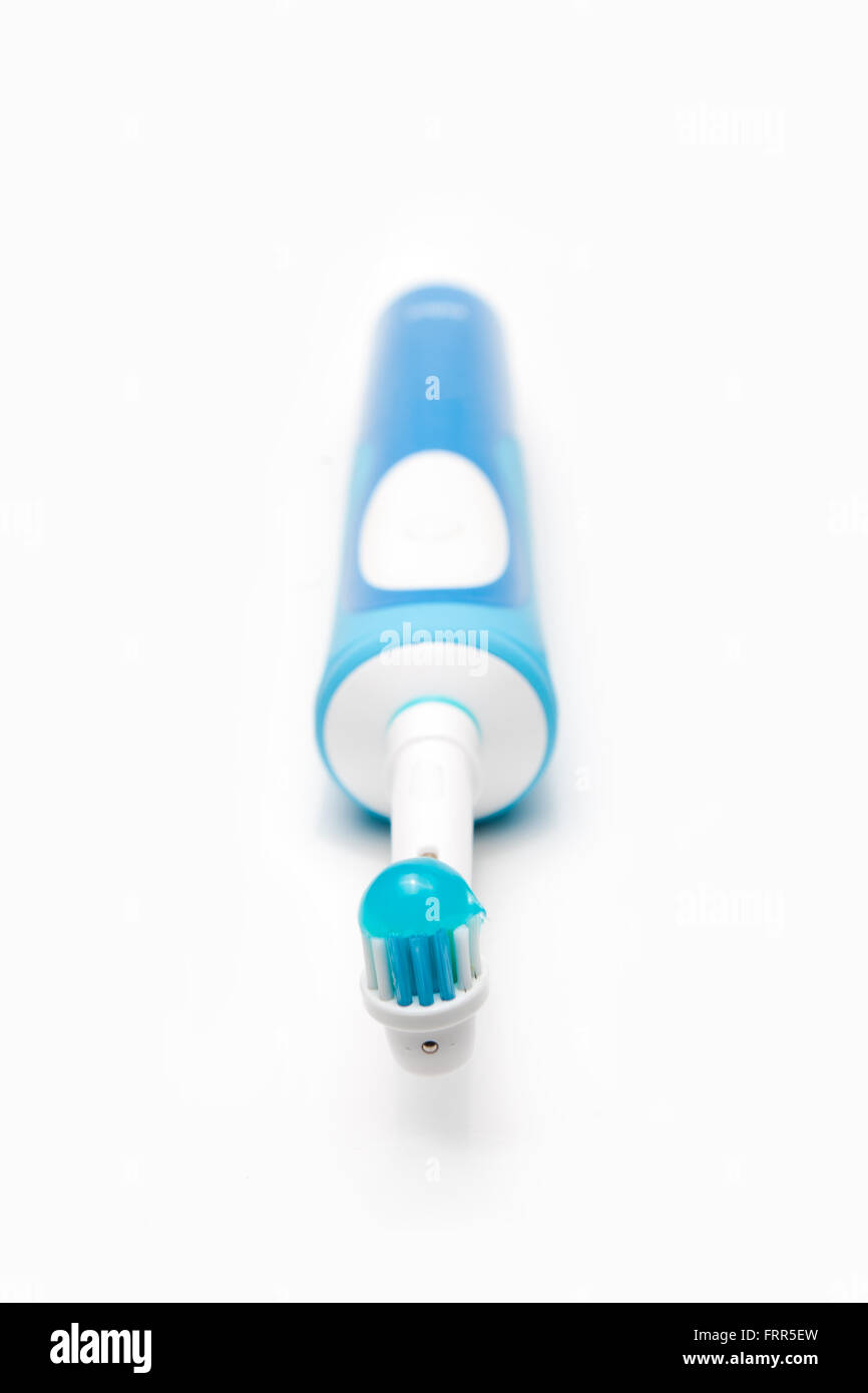 electric toothbrush with toothpaste on white studio background Stock ...