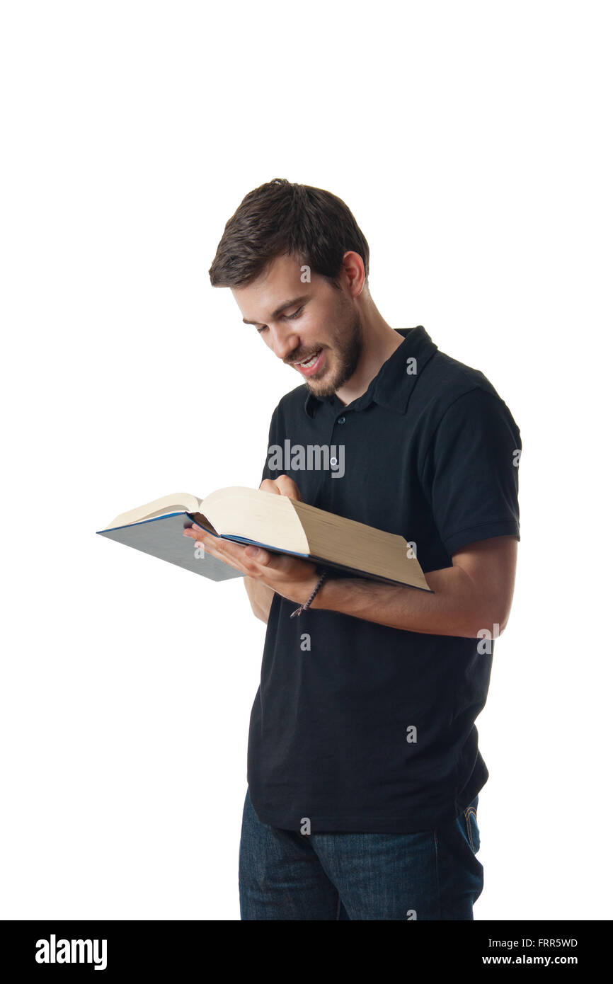 Man standing reading from a large book and smiling isolated on white ...