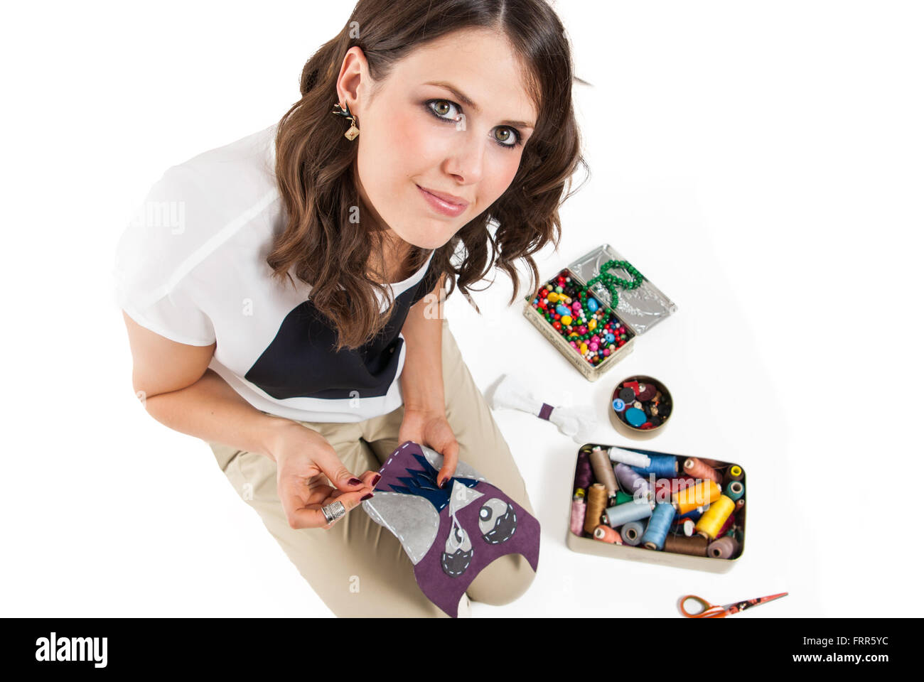 pretty girl sewing fabric on white background Stock Photo - Alamy
