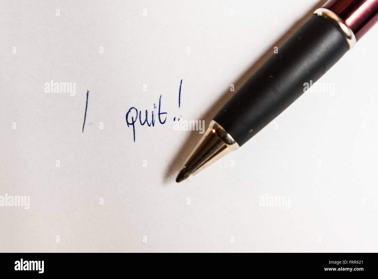 The words I quit on a piece of paper Stock Photo - Alamy