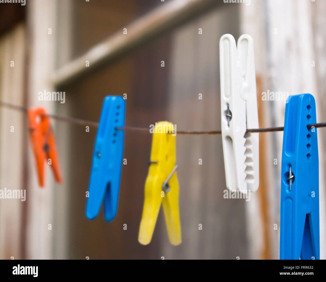 clothes peg lined on a wire Stock Photo - Alamy