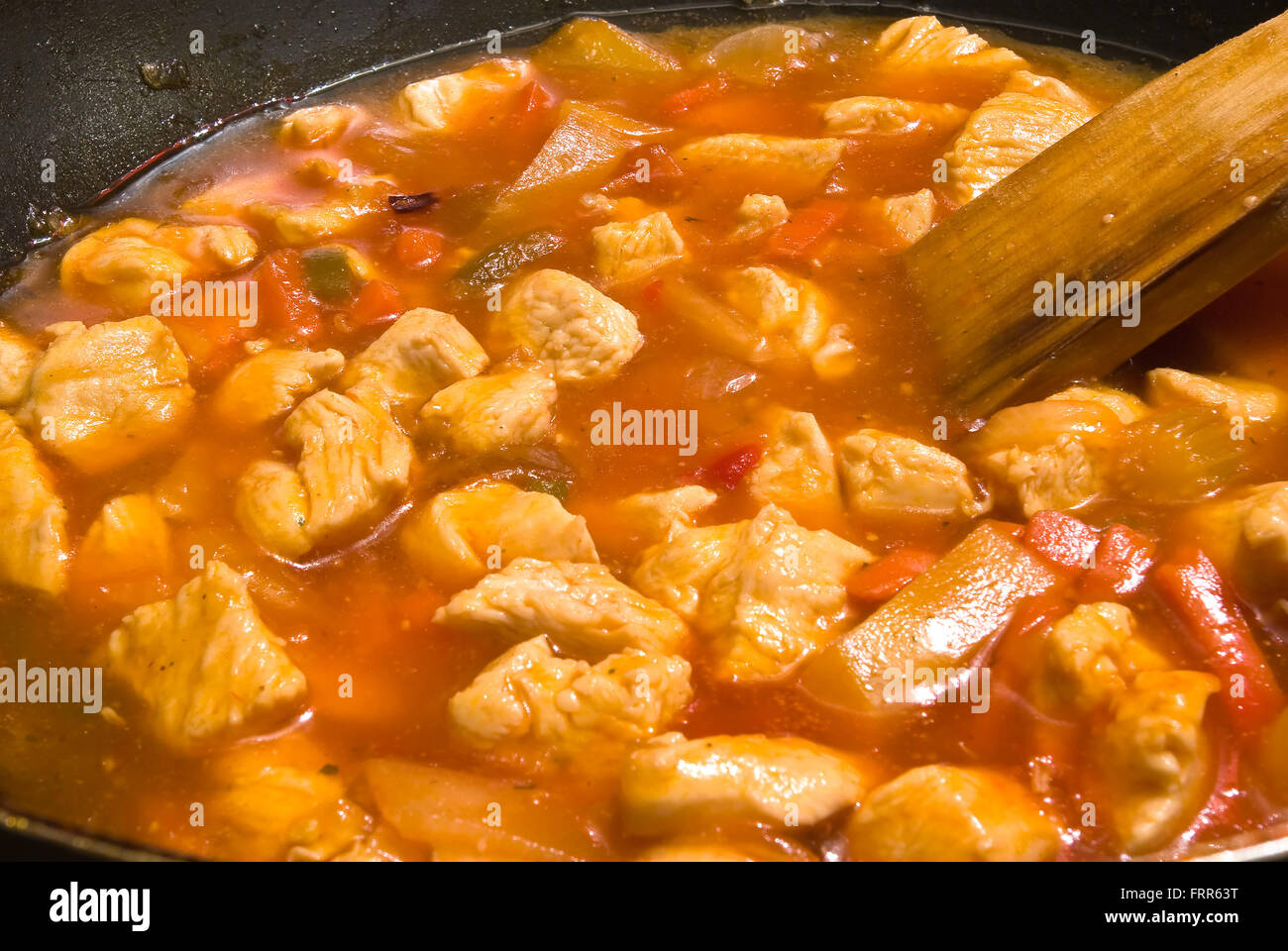 chopped chicken cooking in a sweet and sour sauce, chinese food Stock ...