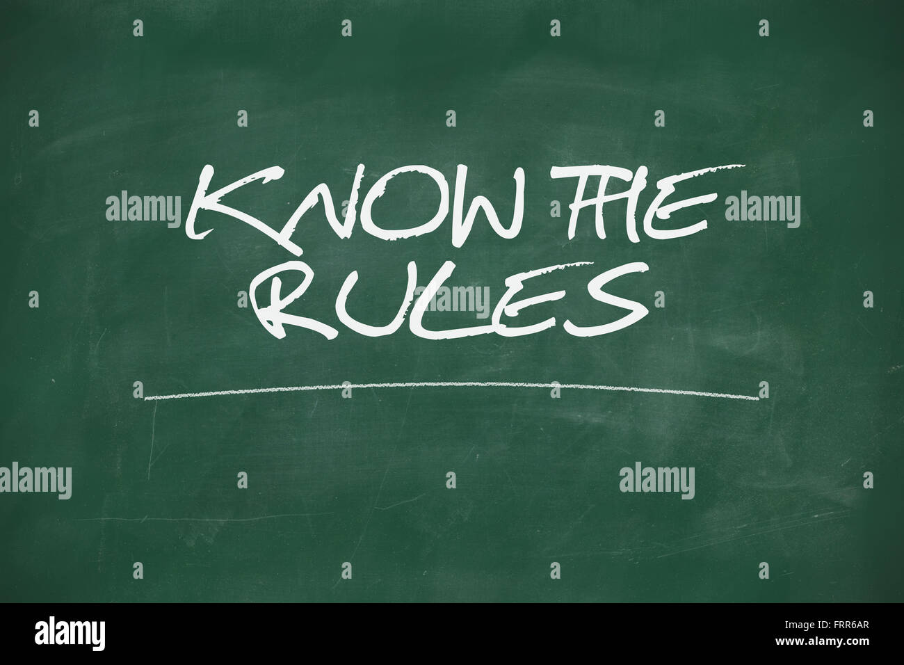 Conceptual "Know the rules" text handwritten on black chalkboard ...
