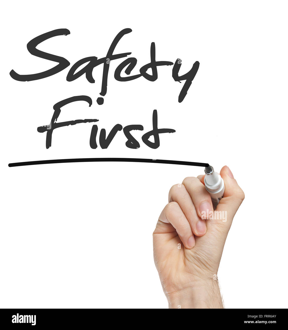 Hand writing Safety First with blackmarker on transparent wipe board ...