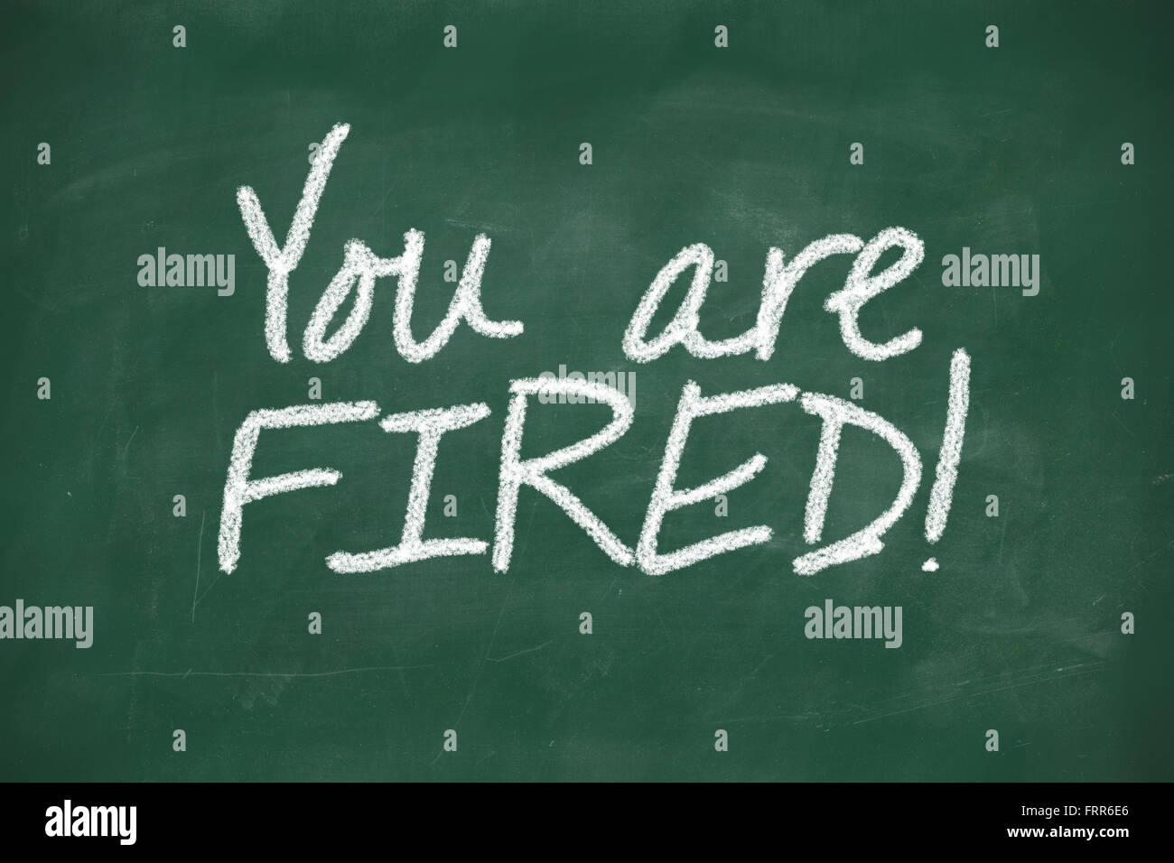 You are fired written on a blackboard Stock Photo - Alamy