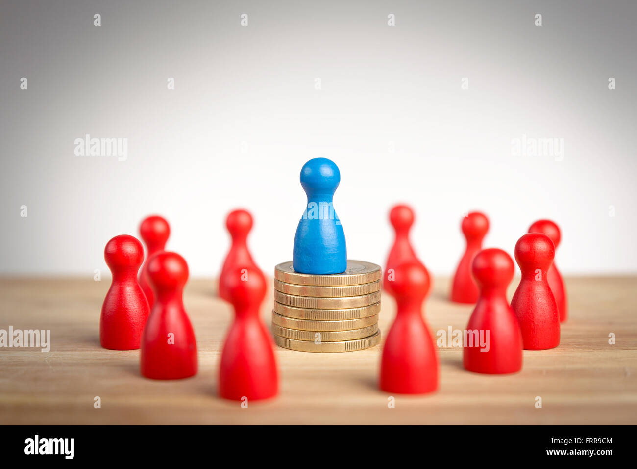 Rich business leader concept with blue figure on top of coin stack as a ...