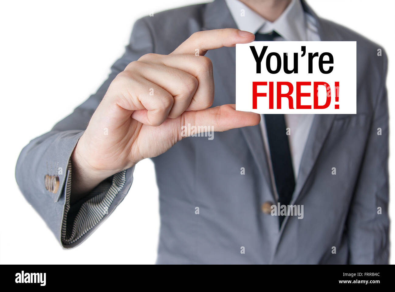 Business man holding a card with you're fired text Stock Photo - Alamy