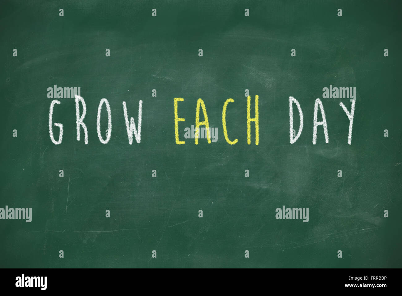 Grow each dayhandwritten on school blackboard Stock Photo - Alamy