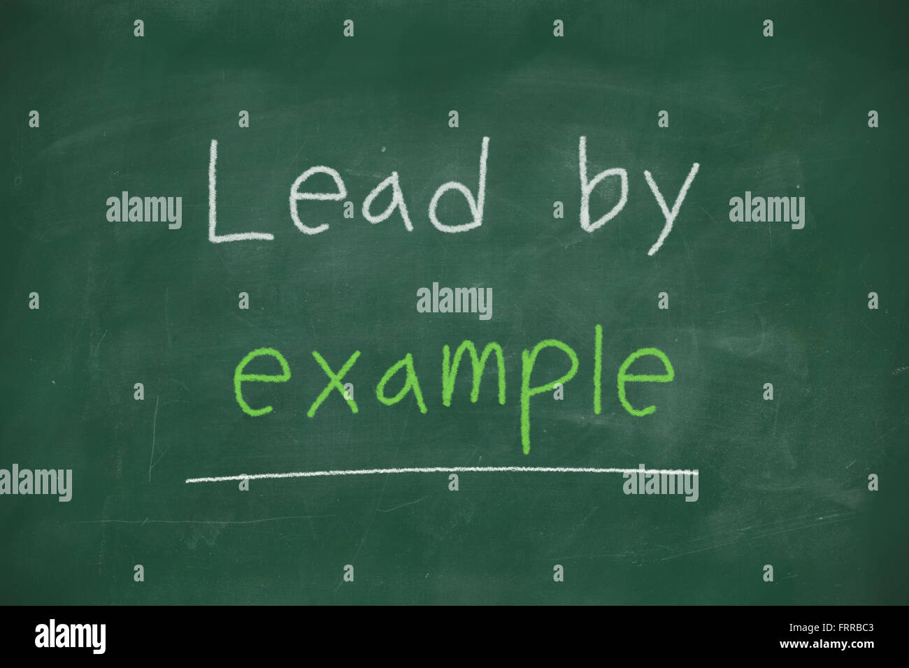 Lead by example handwritten on school blackboard Stock Photo - Alamy