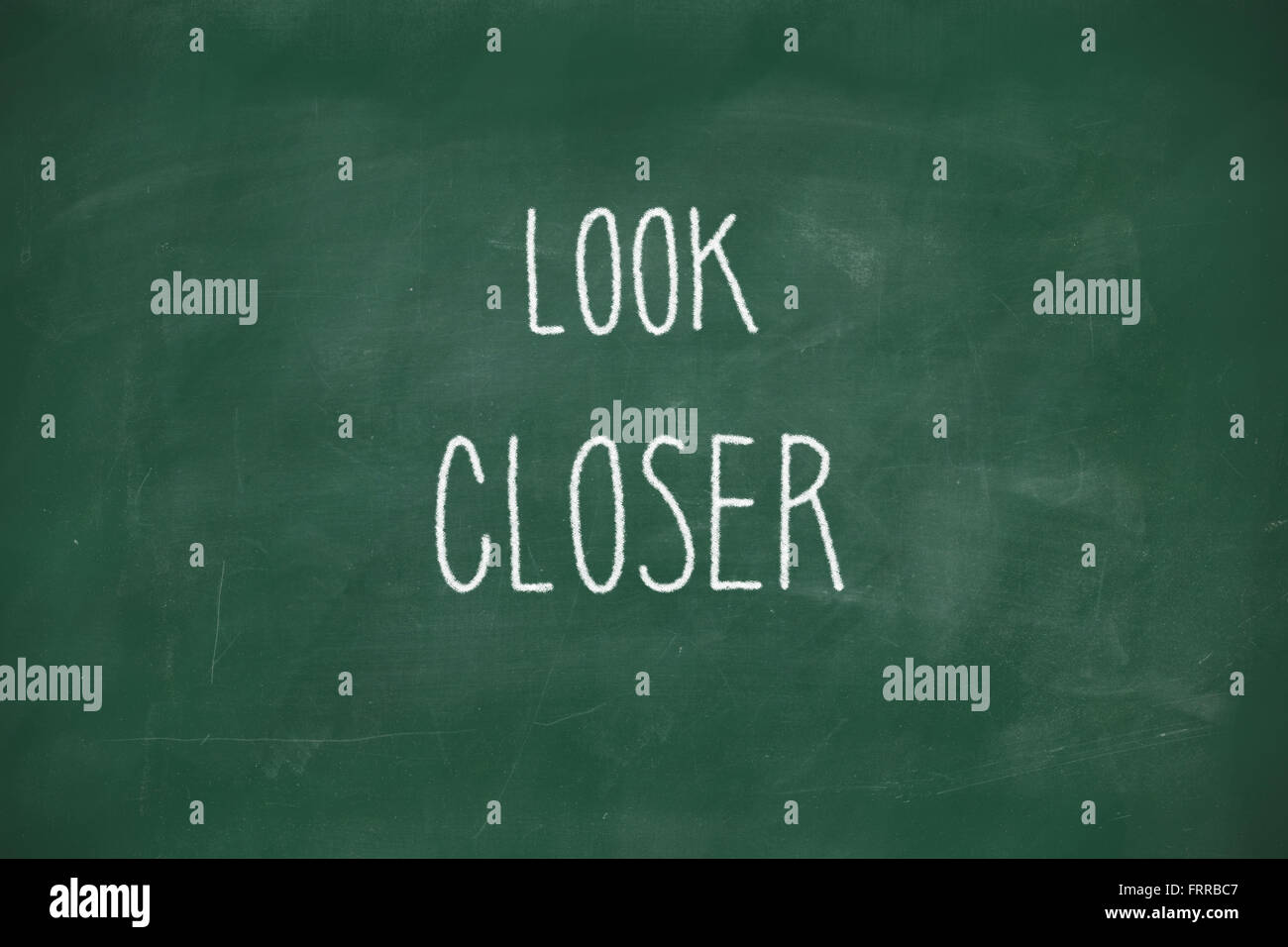 Look closer handwritten on school blackboard Stock Photo - Alamy