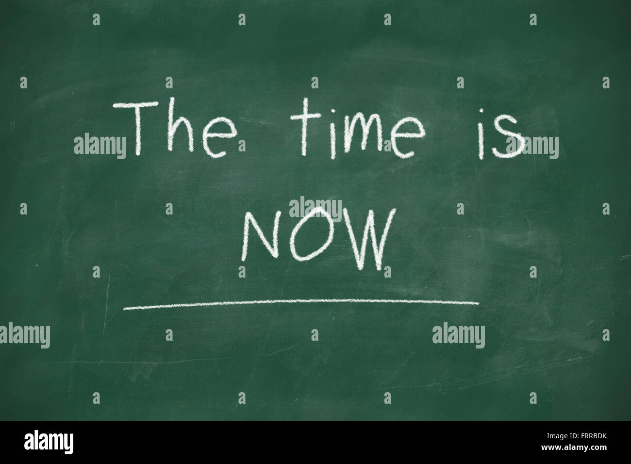 The time is now handwritten on school blackboard Stock Photo - Alamy