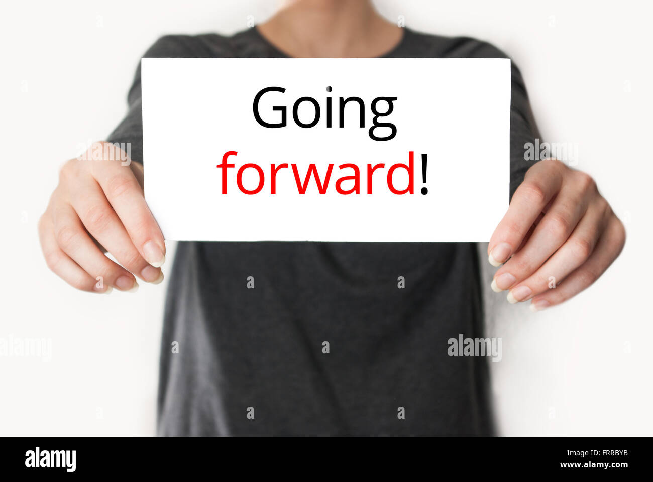 Going forward. Female in black shirt showing or holding a card Stock ...