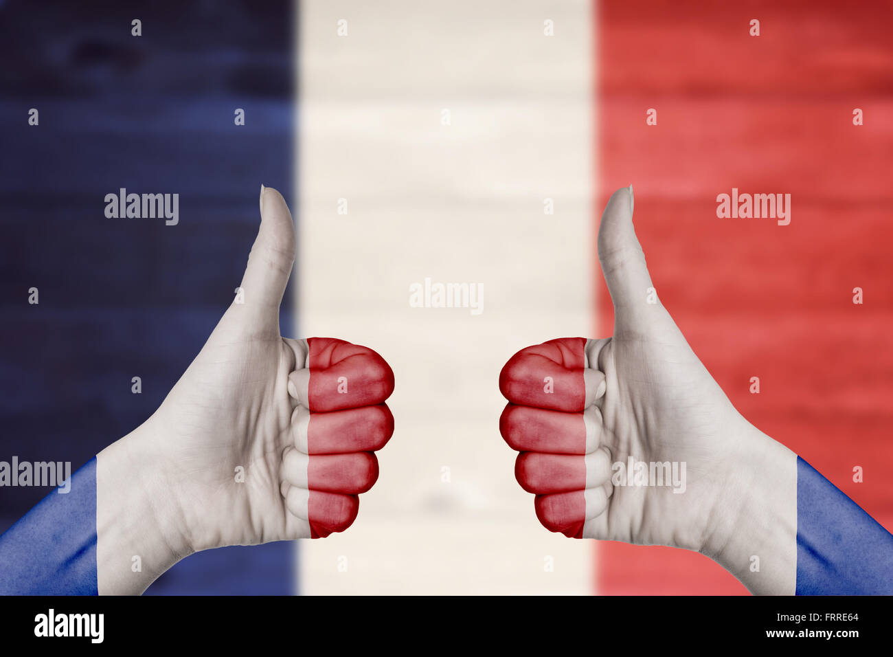 France flag painted on female hands thumbs up with blurry wooden ...