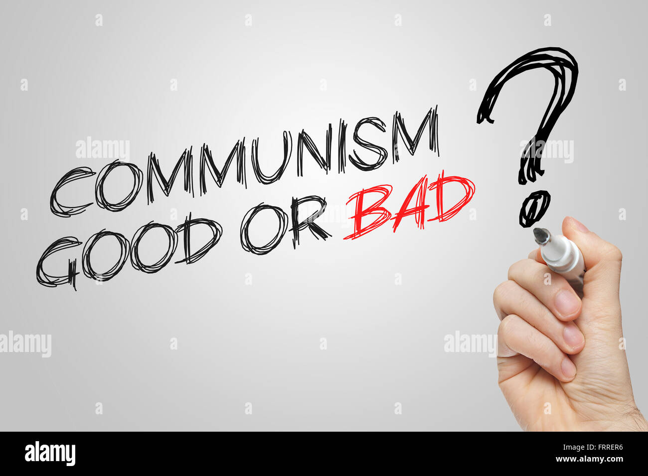Hand writing communism good or bad on grey background Stock Photo - Alamy